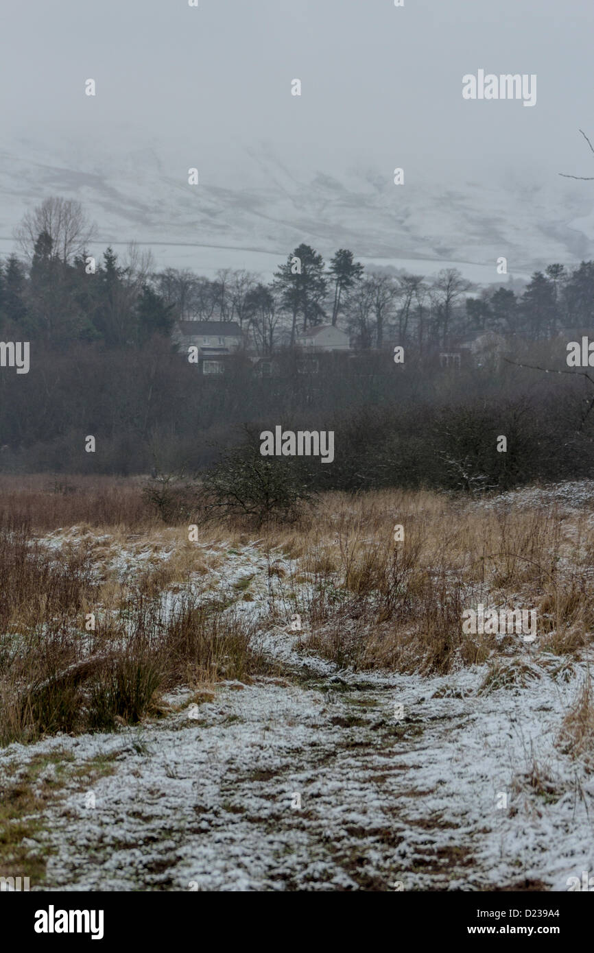 Portrait view of a snowy field with a view of the Campsie hills ...