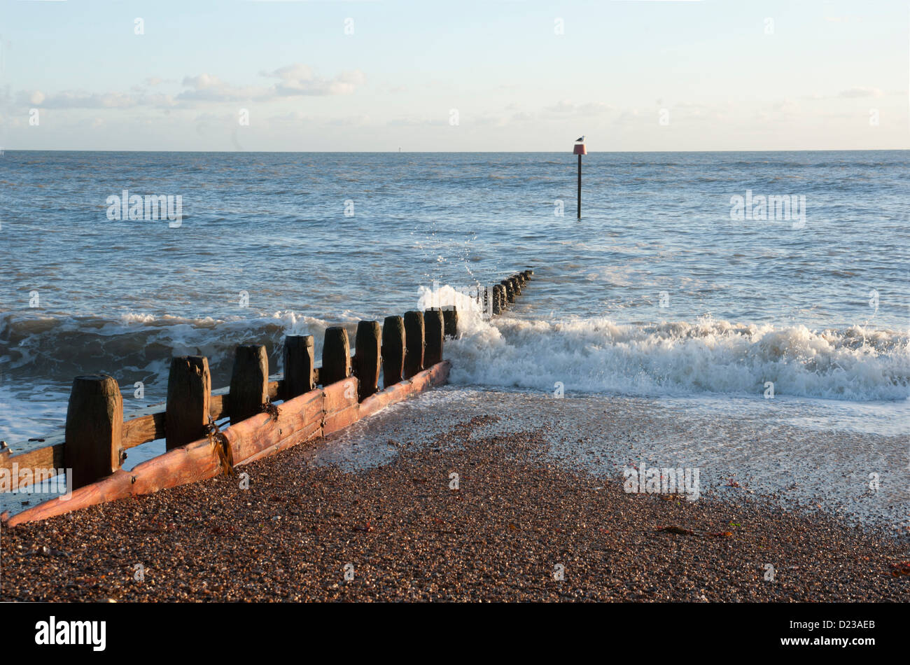 Wooden groynes on a beach in Rustington, West Sussex, UK Stock Photo ...