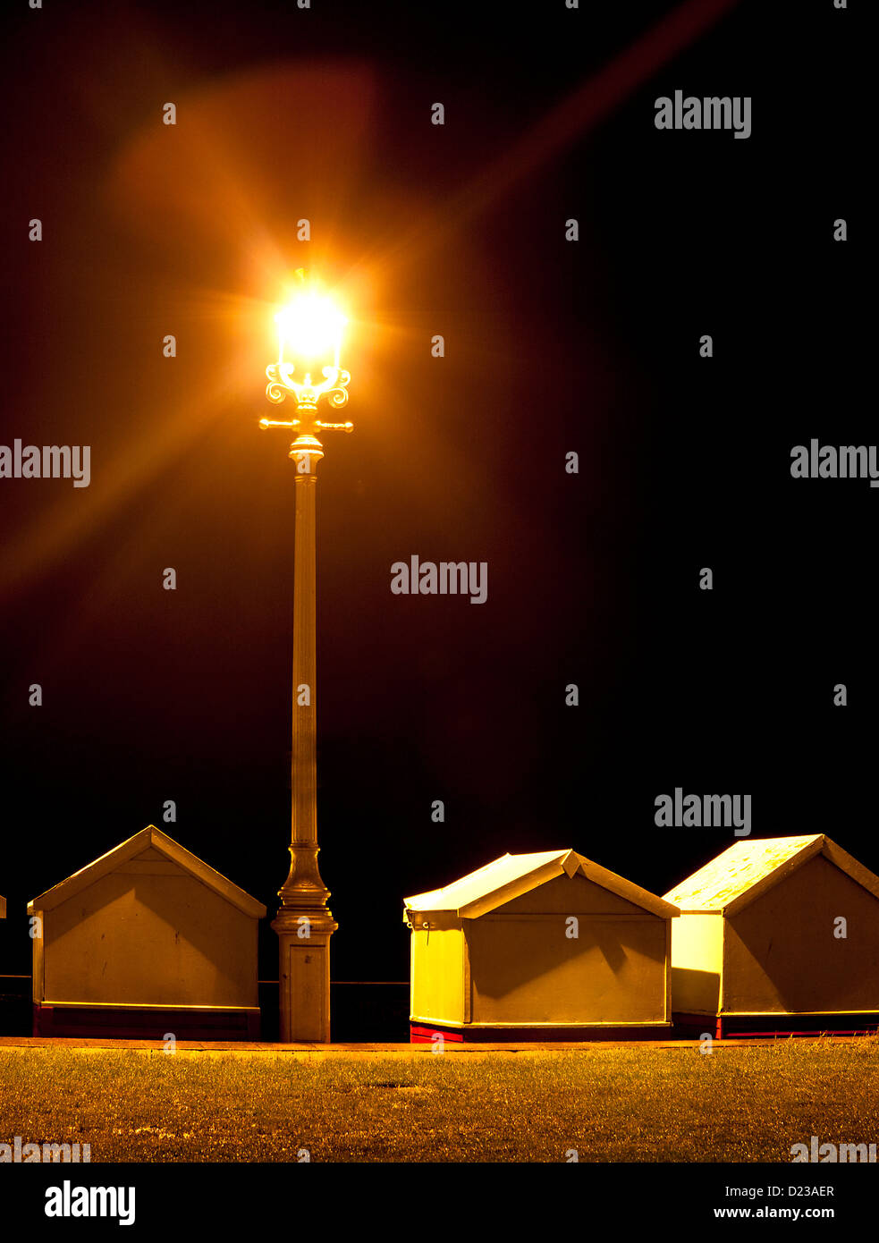 Beach Huts at Night Under a Street Light Stock Photo - Alamy