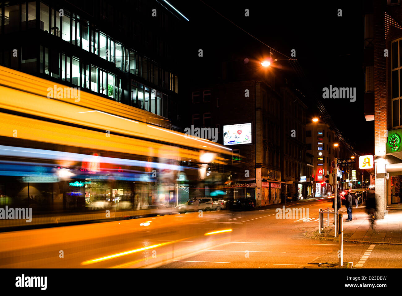 Vivid night scenery showing light traces of a bus passing by in long ...