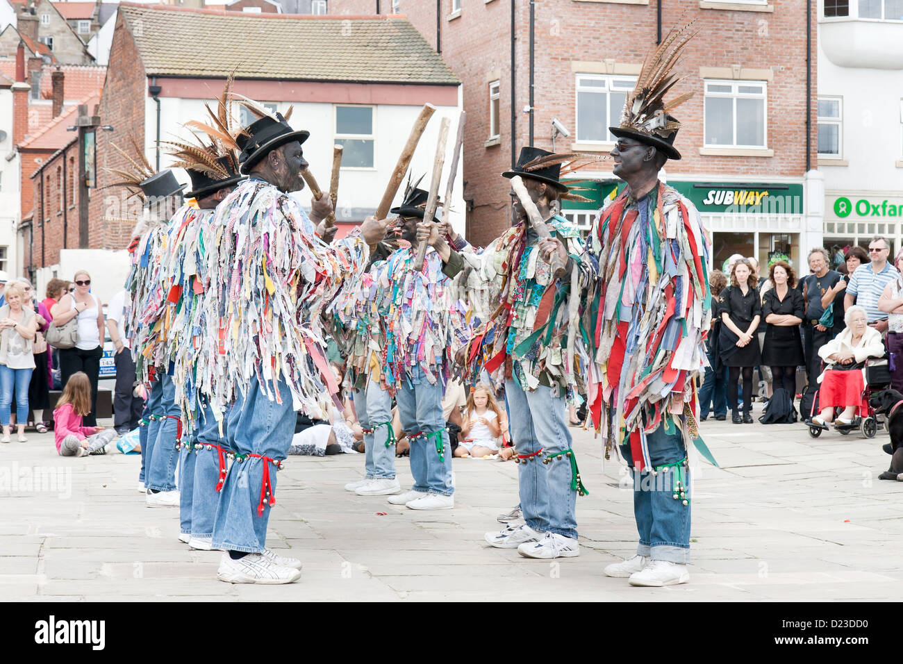Folk dancing at the Whitby Folk Week 2012 with black faced male morris ...
