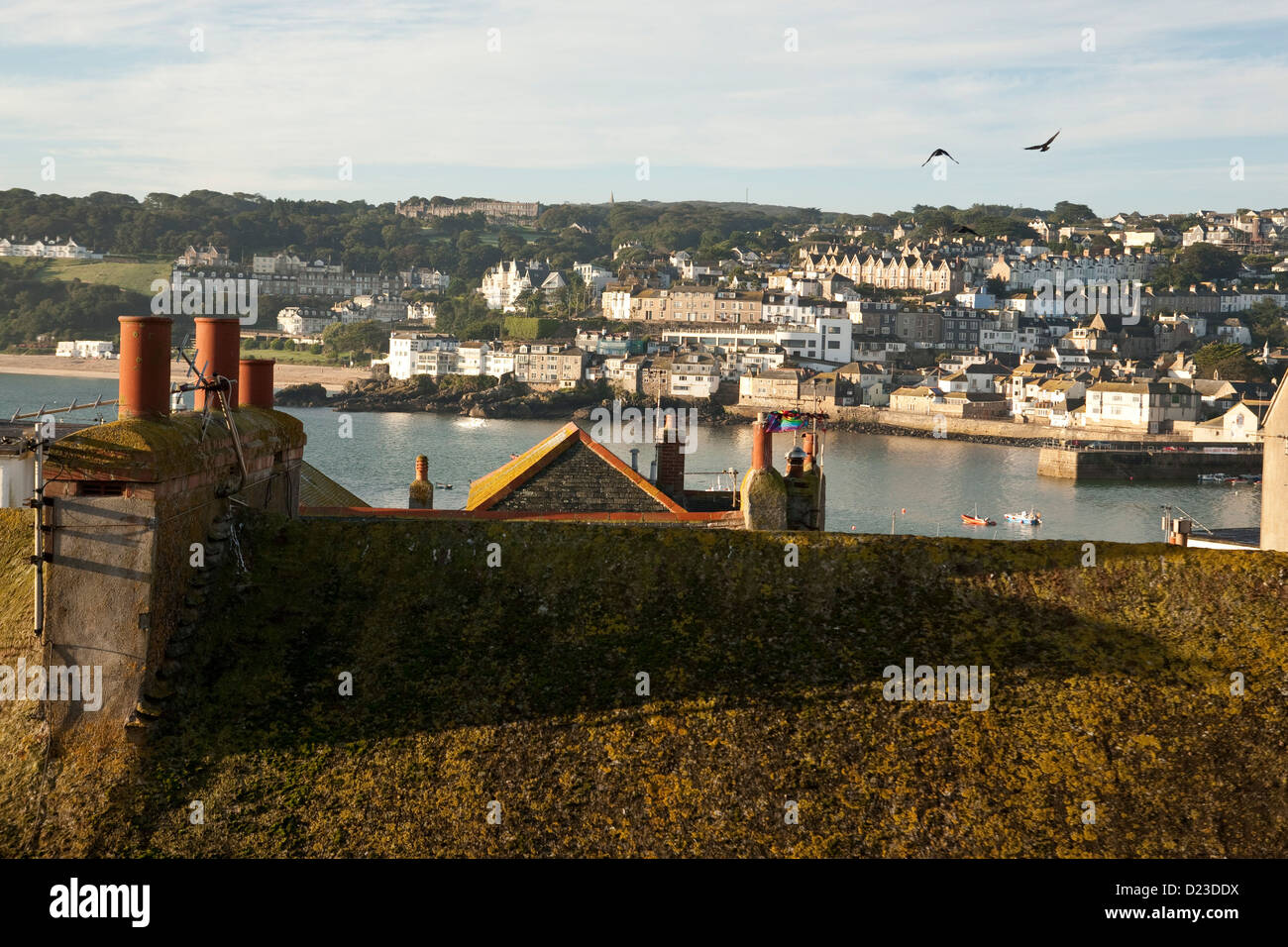 rooftops and chimneys of St Ives with the sea and harbour Stock Photo ...