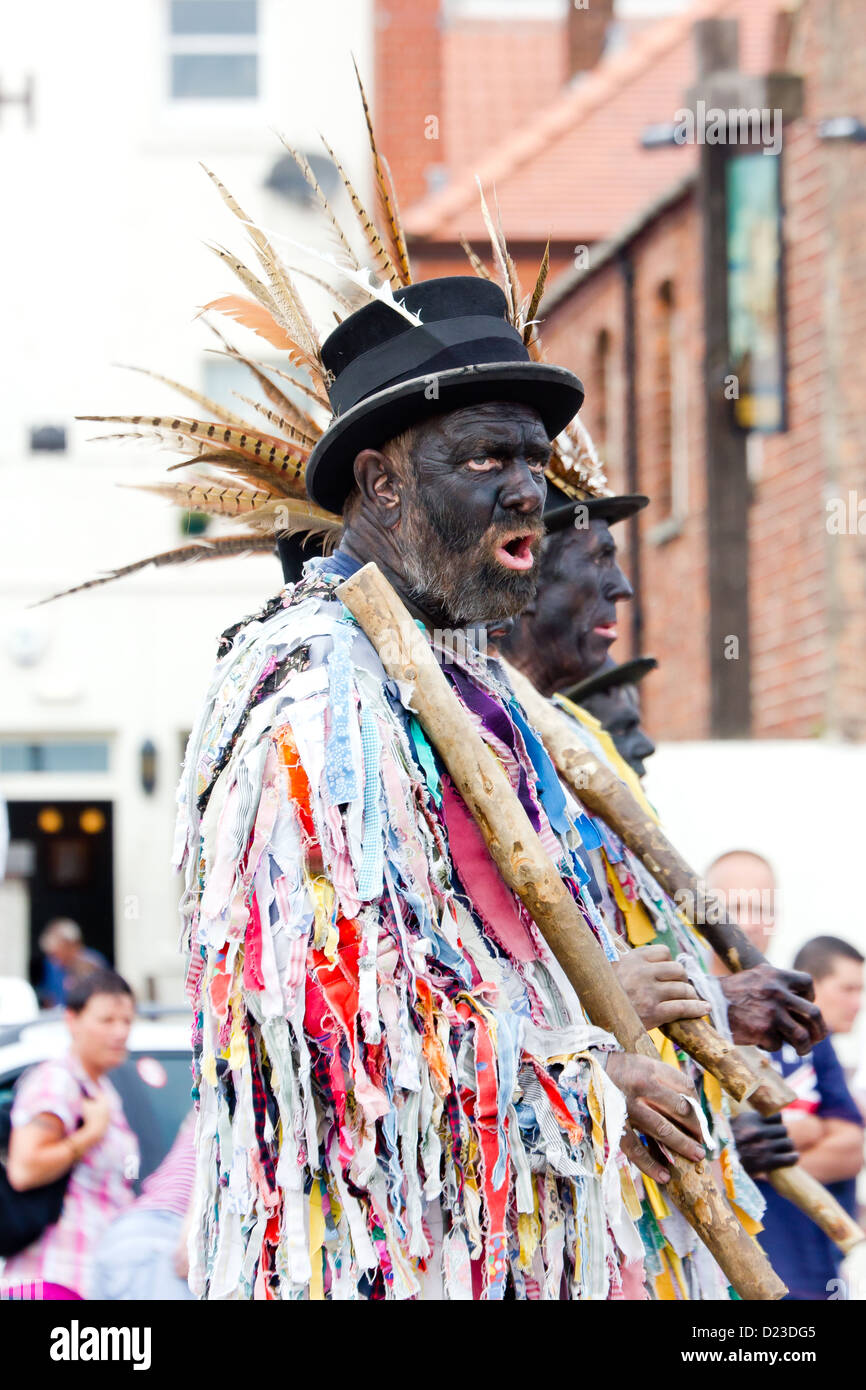 Folk dancing at the Whitby Folk Week 2012 with a black faced male ...