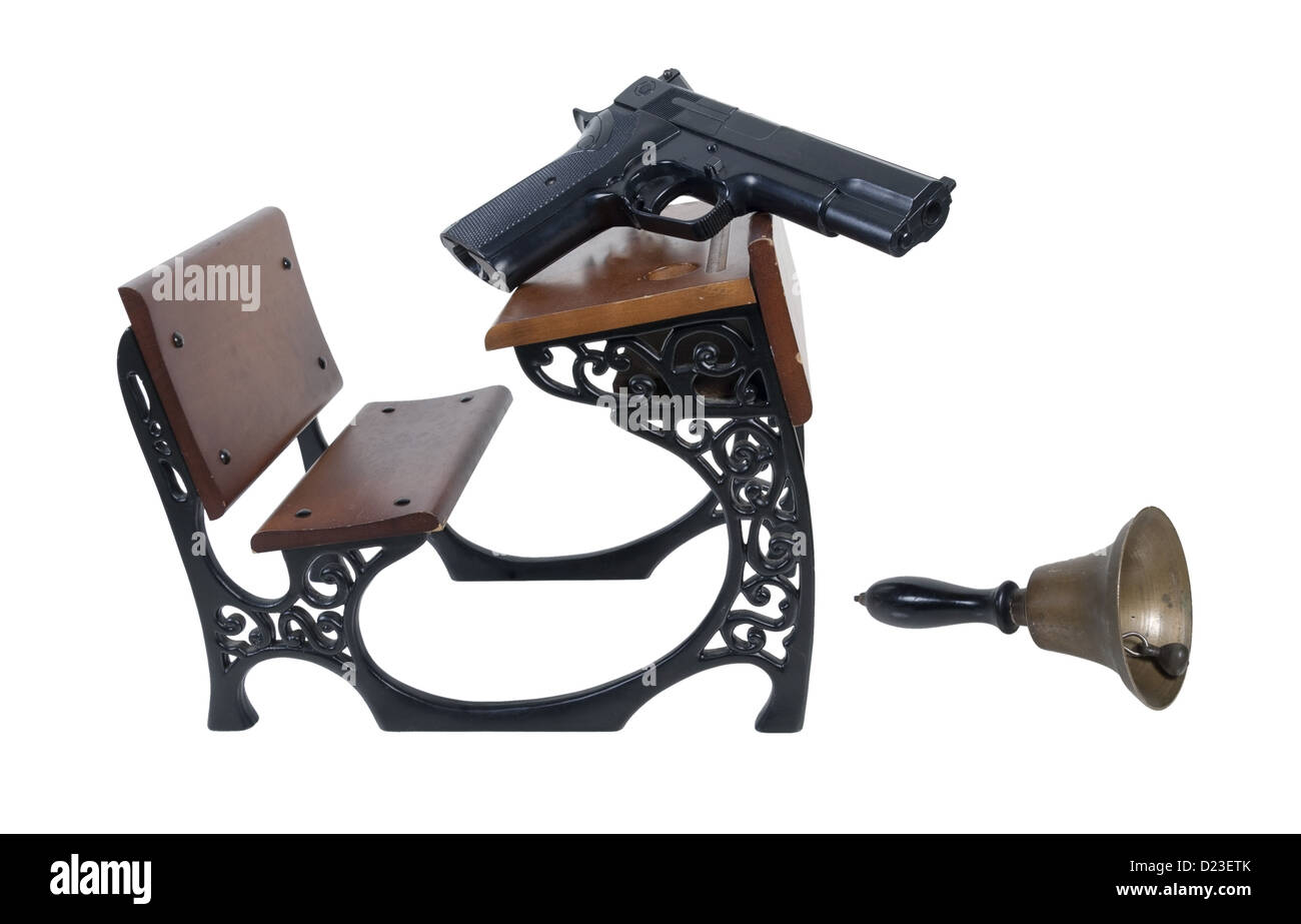 Gun on a Vintage wooden student desk with school bell - path included ...