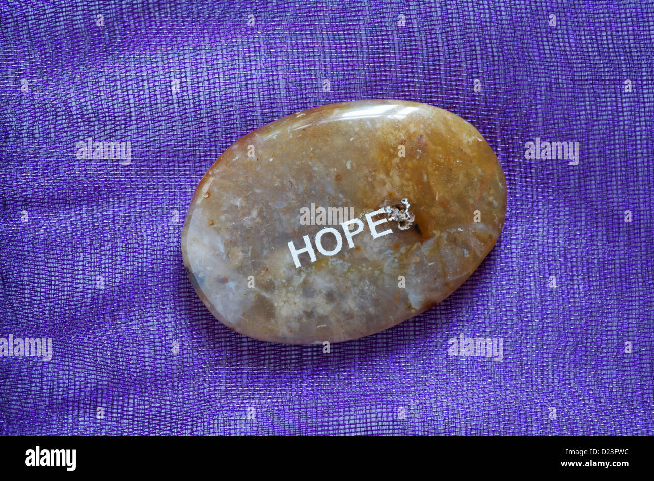 Hope Fair Trade sentiment pebbles - Hope pebble isolated on purple ...