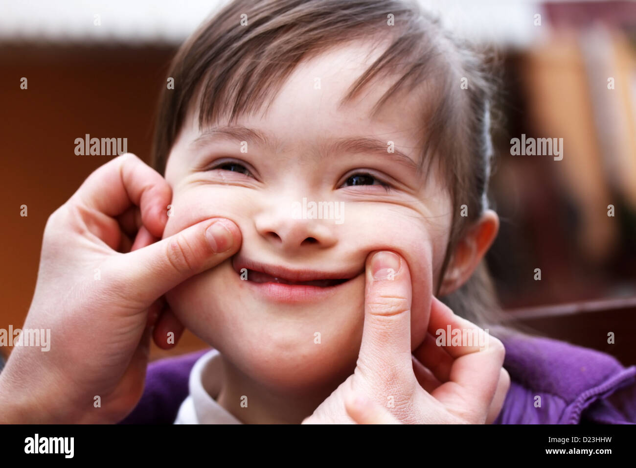 Portrait of girl with hands that make a smile Stock Photo - Alamy
