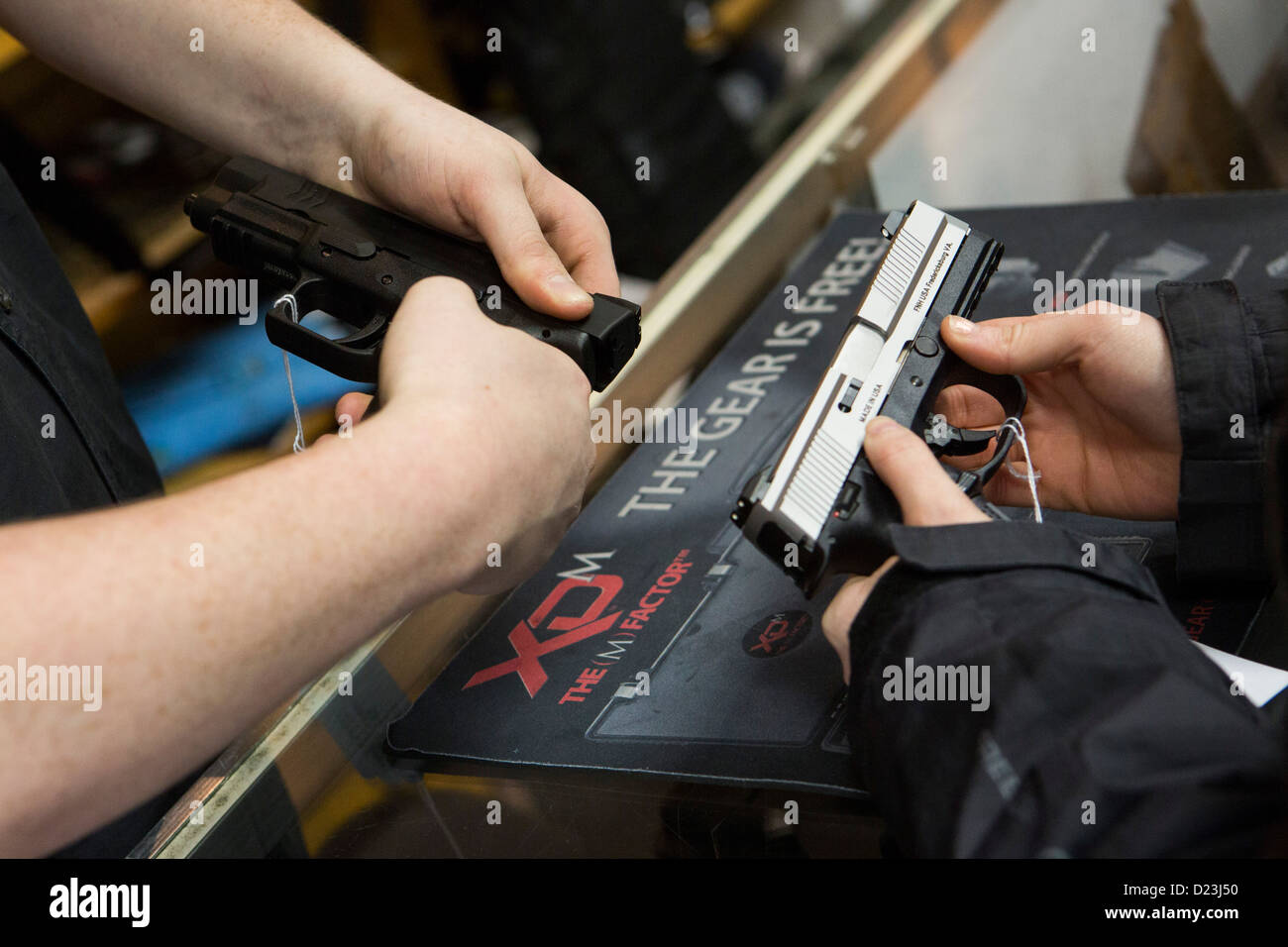 Hand holding gun store hi-res stock photography and images - Alamy