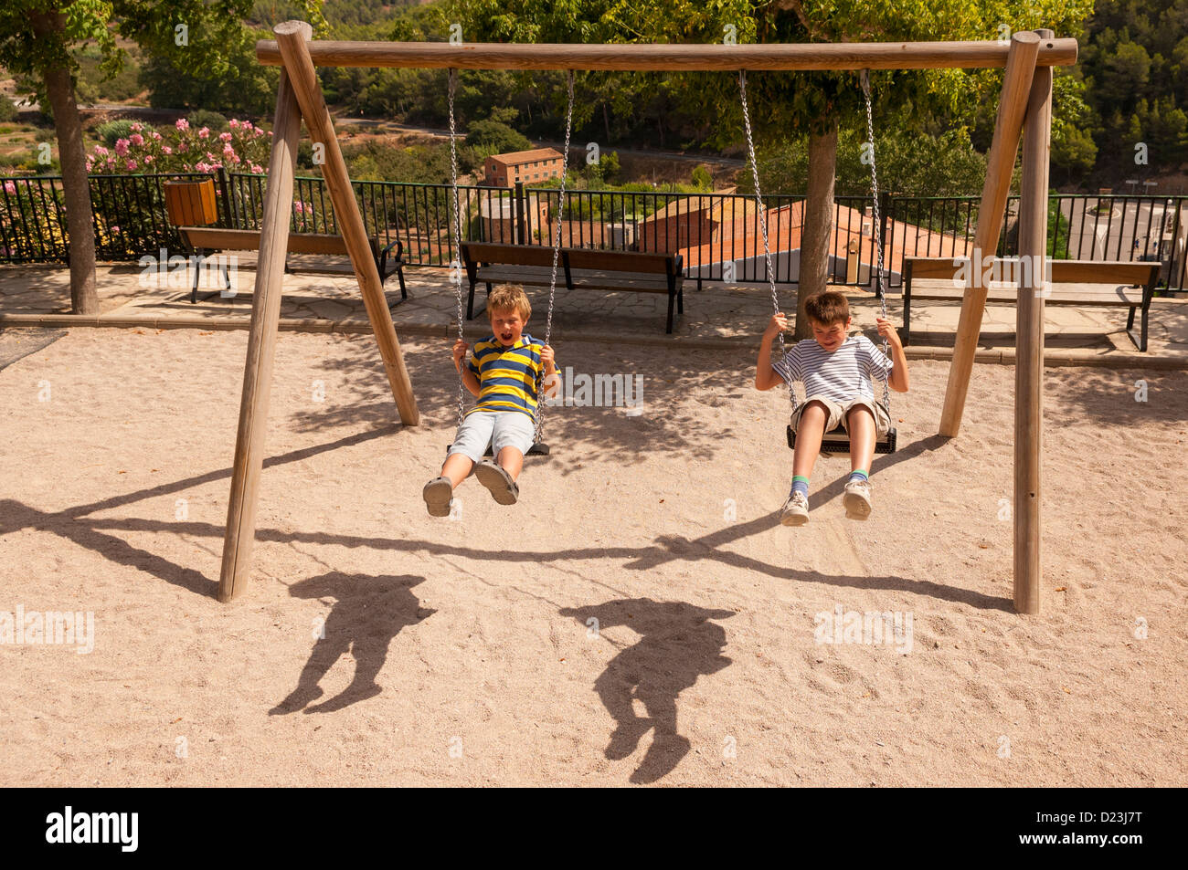 Two boys playing on swing hi-res stock photography and images - Alamy