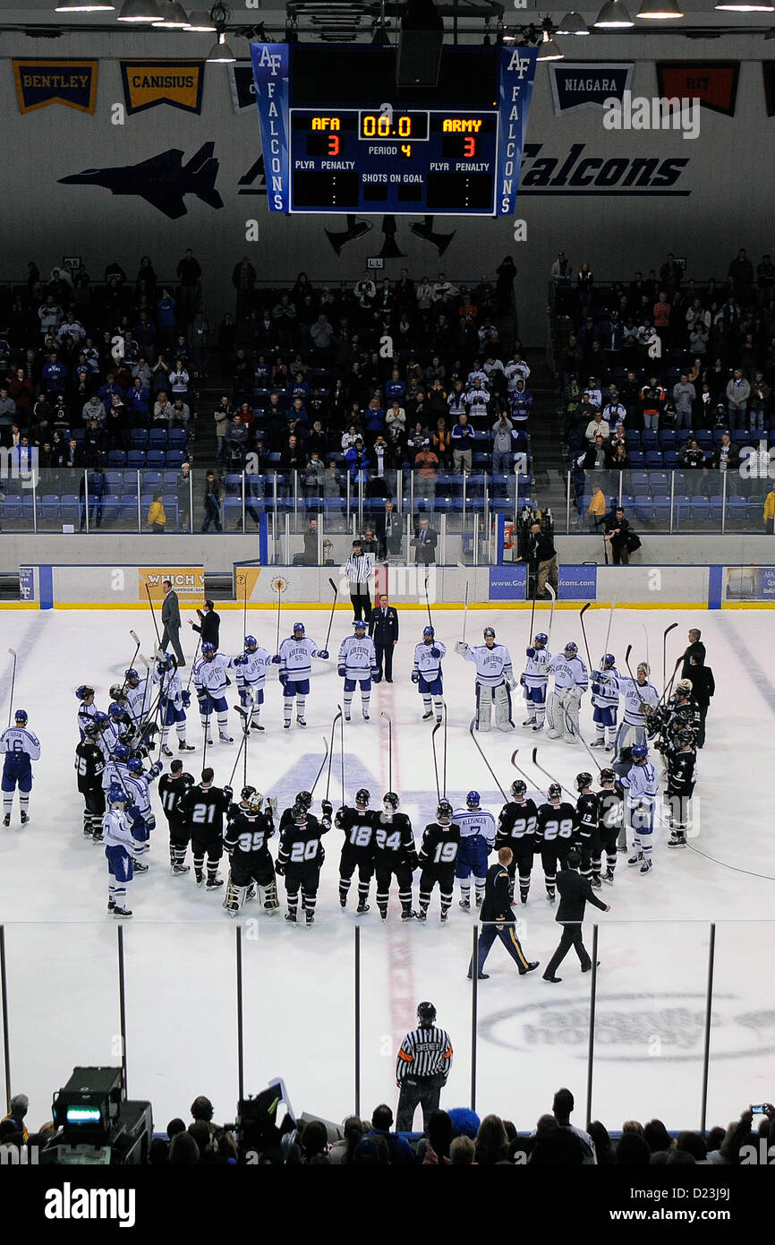 Members of the U.S. Air Force and U.S. Army hockey teams salute each ...