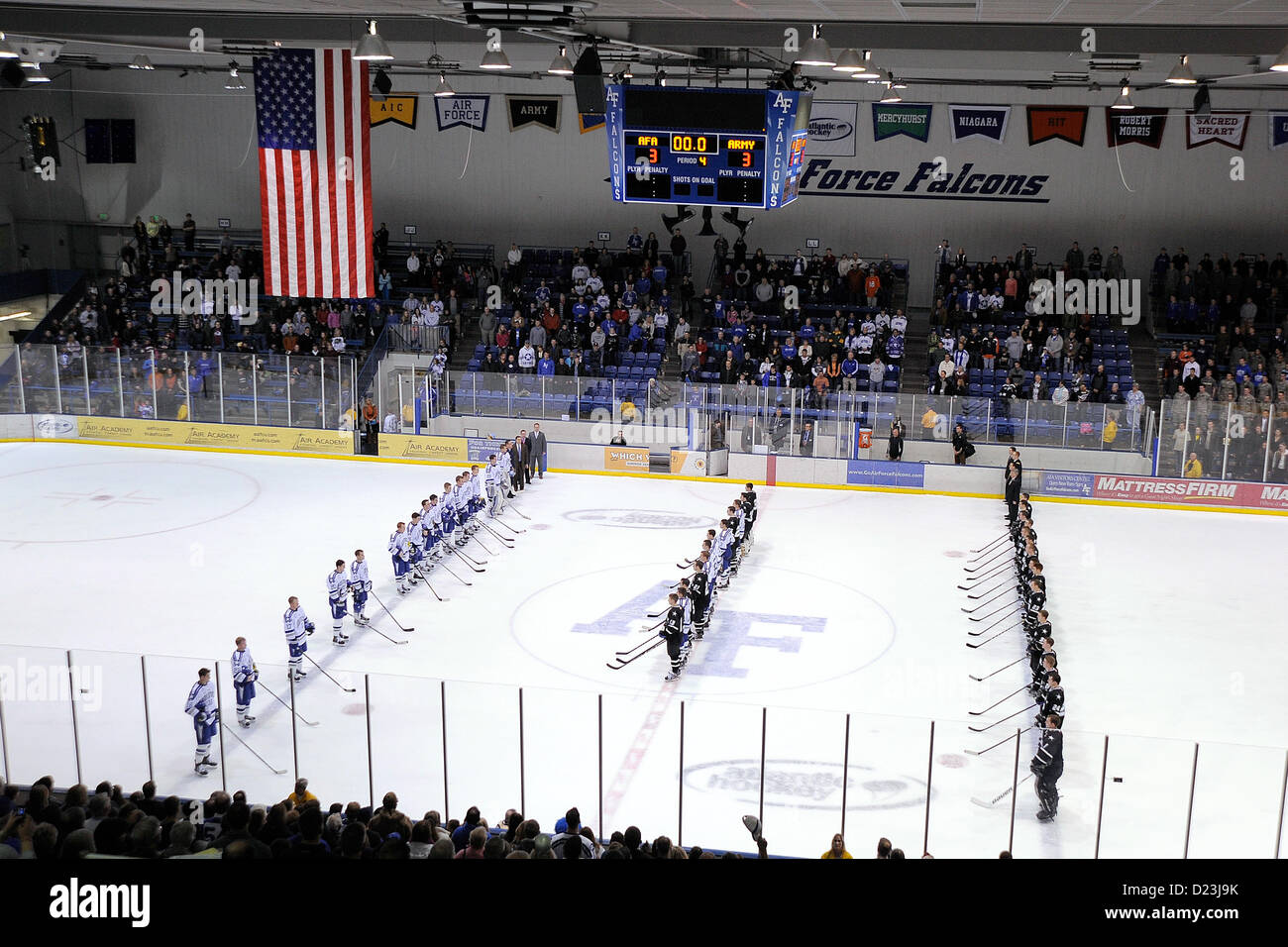 Air Force and Army seniors gather on the ice during a ceremonial event ...