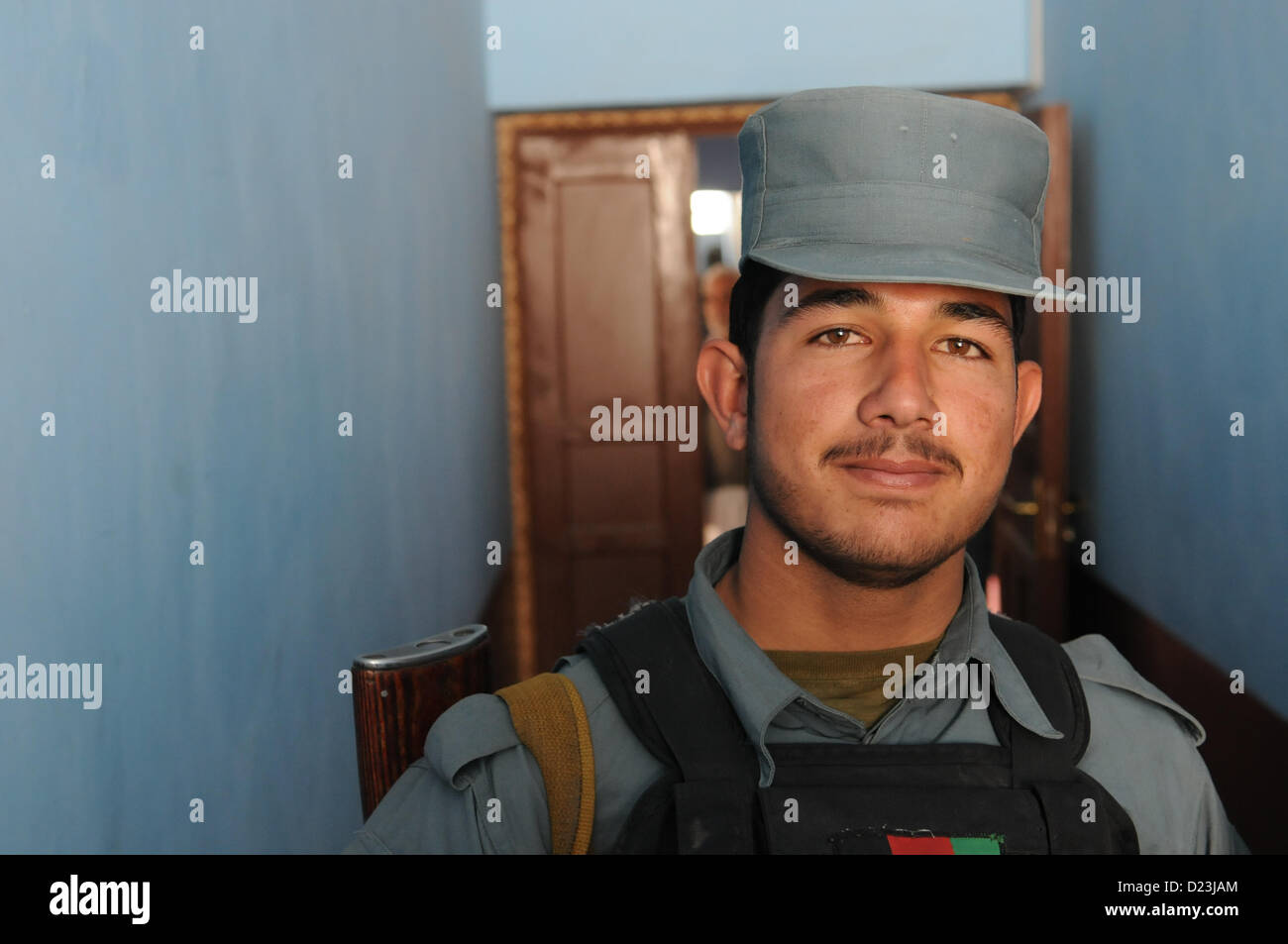 A police force member poses for a photo at the Farah City municipality ...