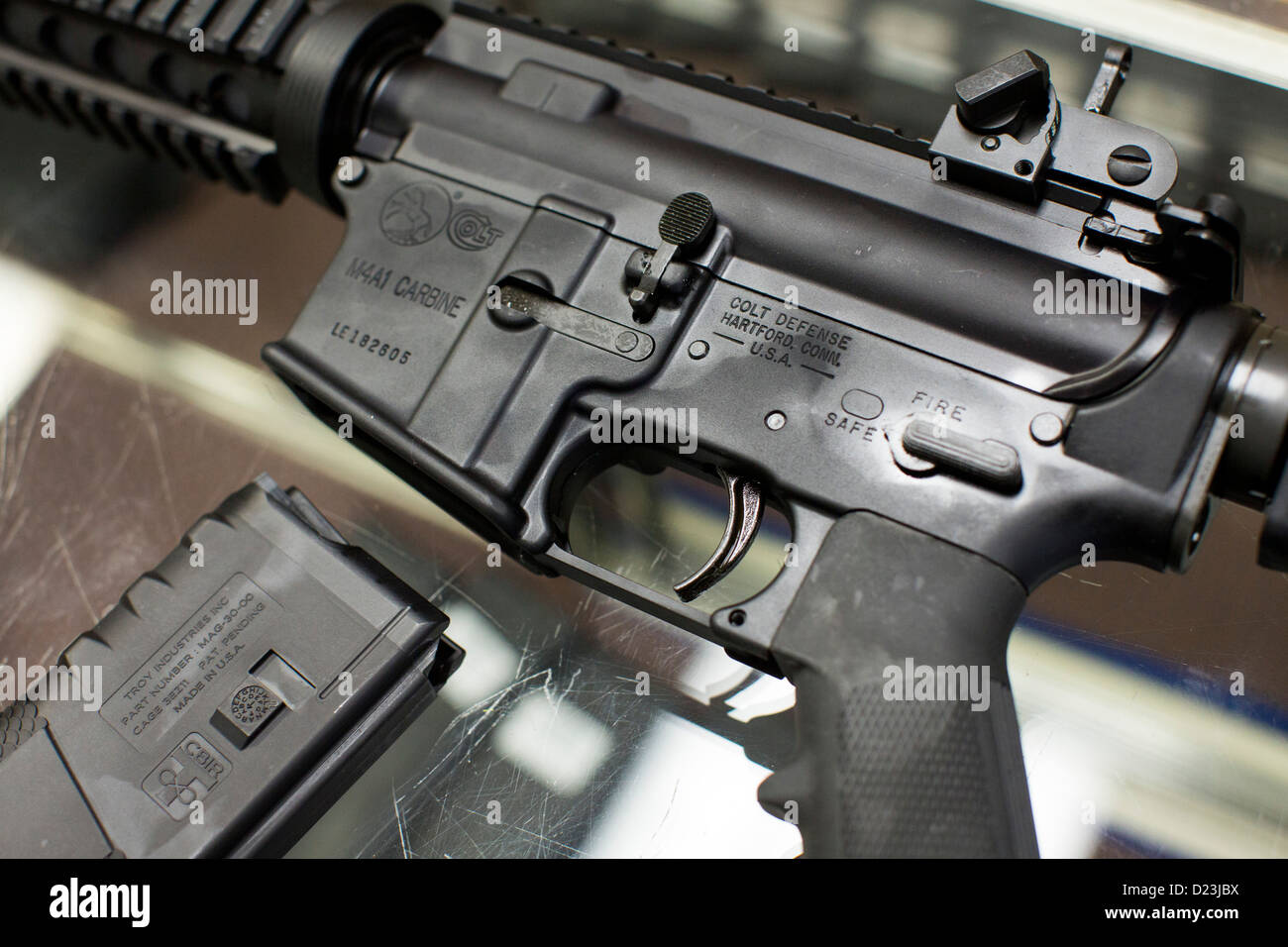A Colt Defense M4A1 Carbine assault rifle on display at a gun shop with ...