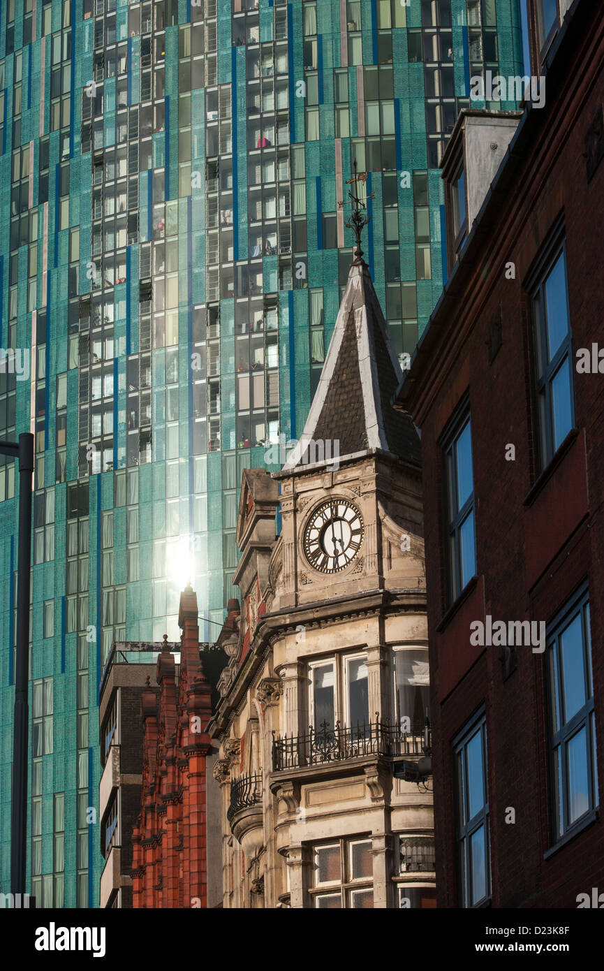 The old and the new. A 19th century clock tower is overshadowed by the ...
