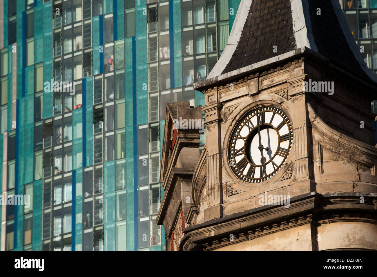 The old and the new. A 19th century clock tower is overshadowed by the ...