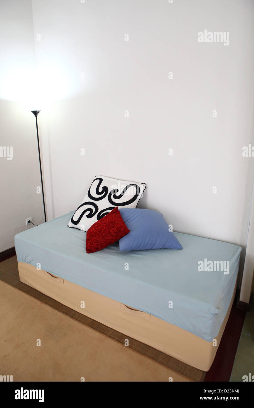 Brown carpet, mattress with colored cushions with lamp lighting withe ...