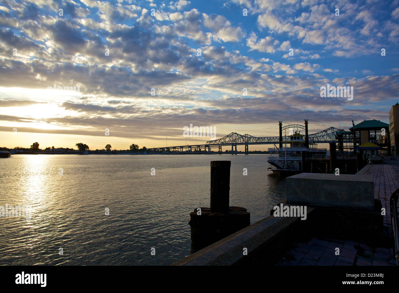 Sunset over the Mississippi River, with a view of the Crescent City ...