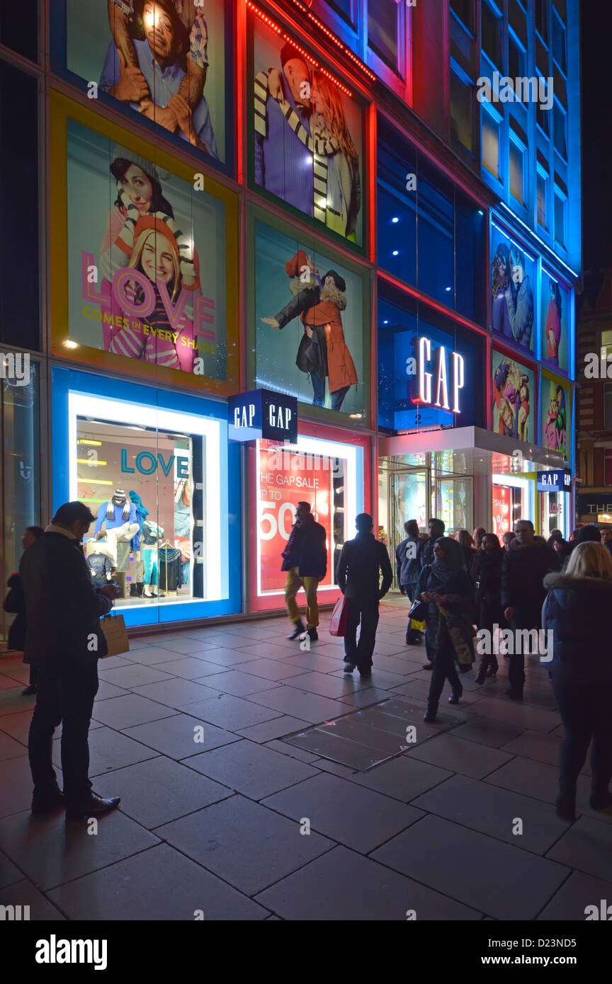 Shoppers outside Gap clothing fashion store shop front window with ...