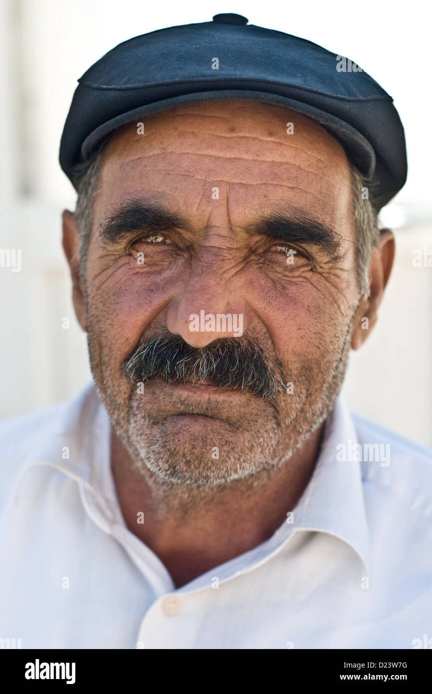 Portrait of a middle aged Kurdish man wearing a hat and moustache, in ...