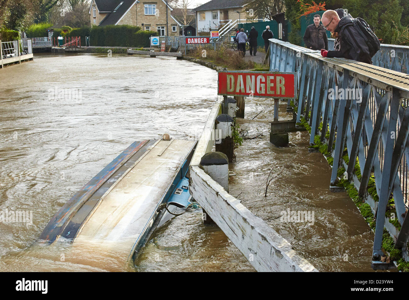 A sunken canal boat pushed up against a weir near Osney Lock on the ...