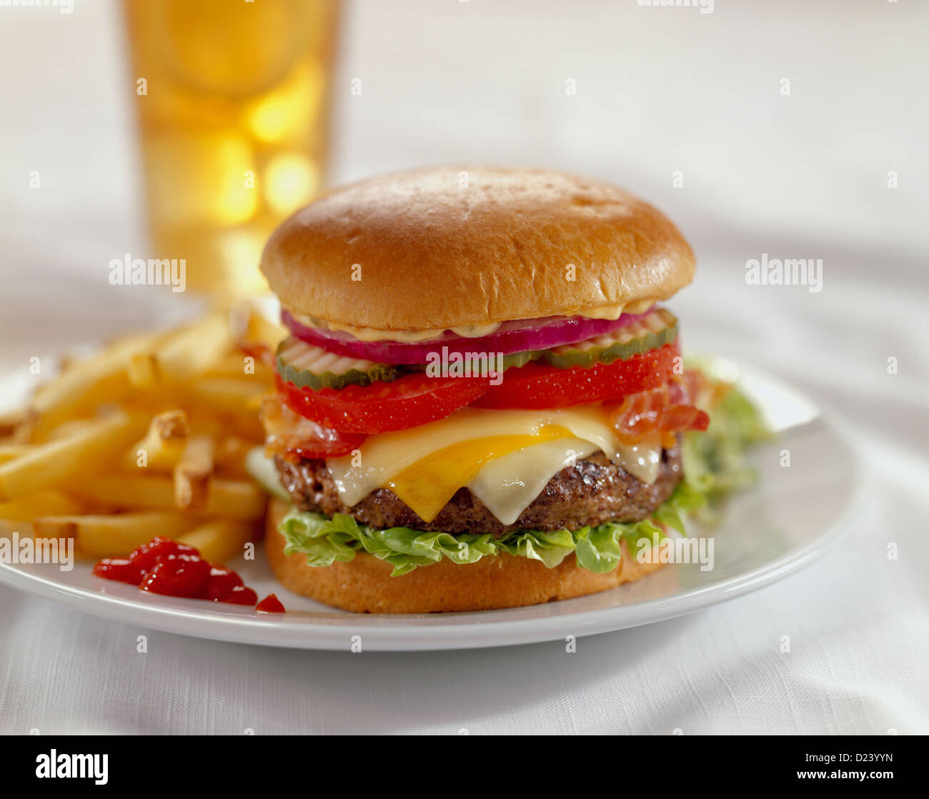 Triple melted cheese burger served with French fries and an ice tea ...