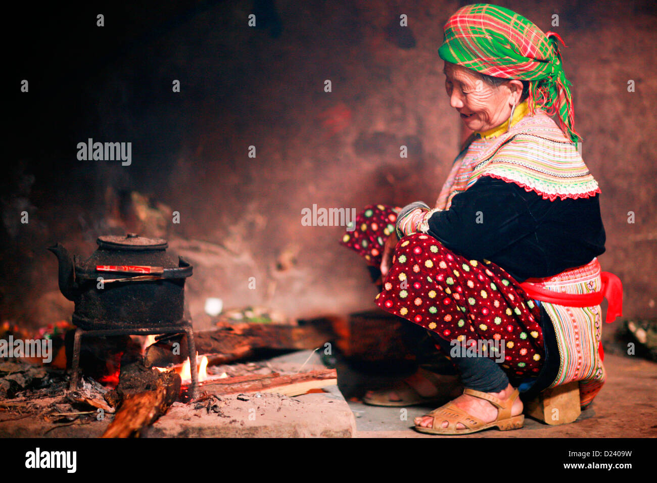 Flower Hmong tribeswoman making tea in her home near Bac Ha in North ...