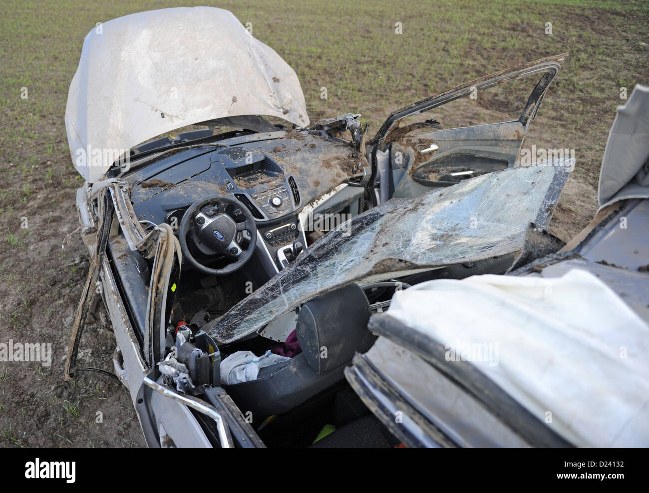 A car, which was hit by a wrong-way driver, stands on a field next to ...