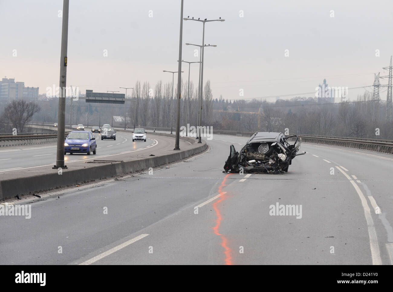 A totally destroyed car is parked on the intercity highway A100 in ...