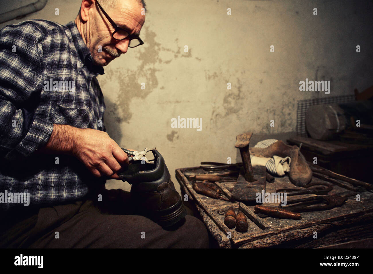 cobbler at work with old tools Stock Photo - Alamy