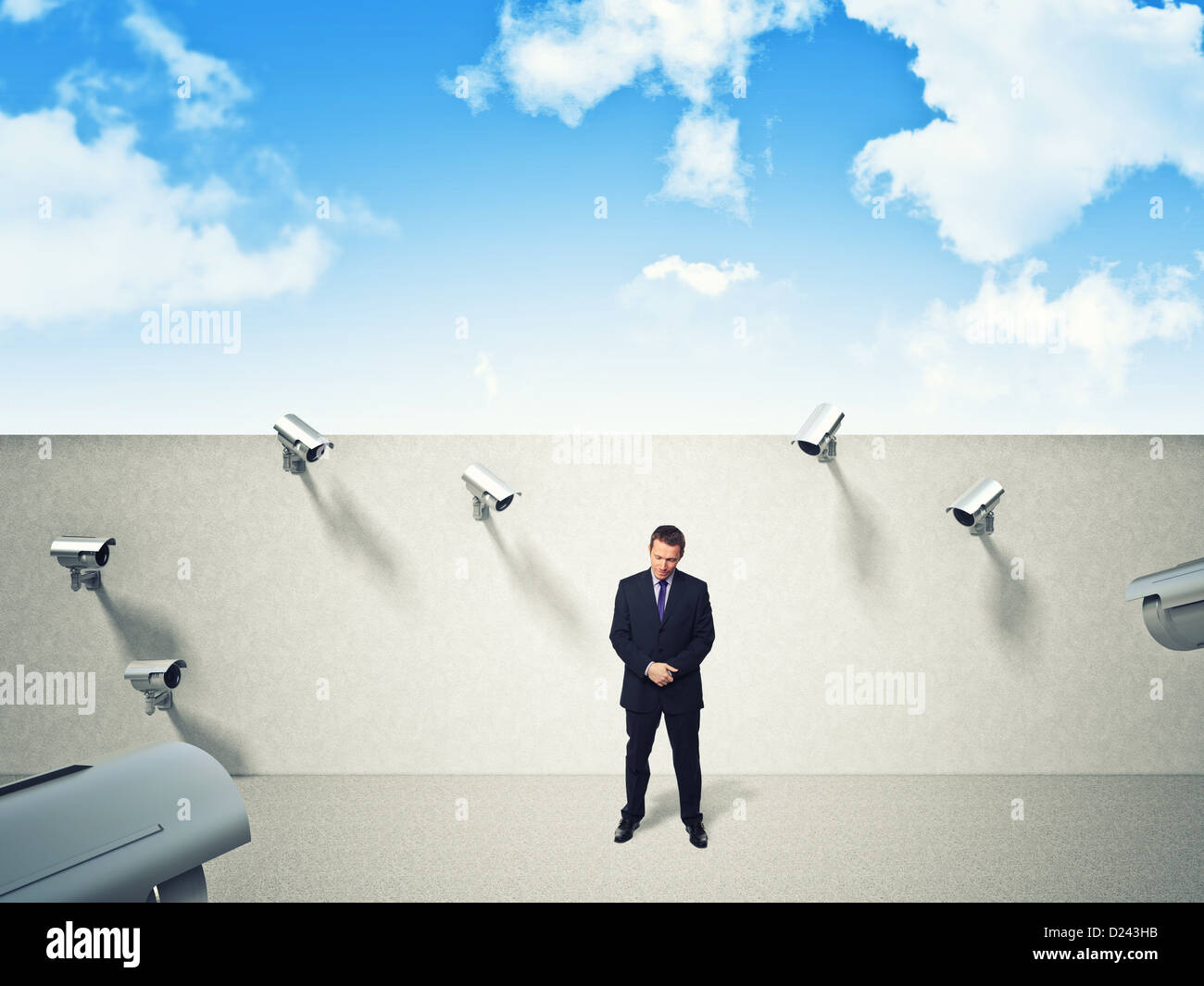 standing businessman and lots of cctv cameras Stock Photo - Alamy