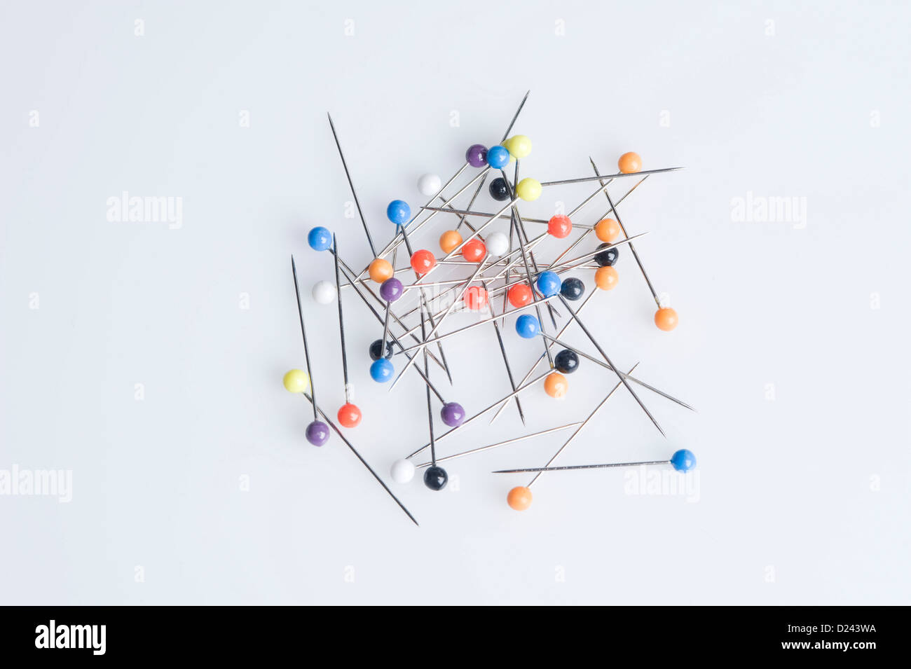 Variety of pins with needles on white background Stock Photo - Alamy