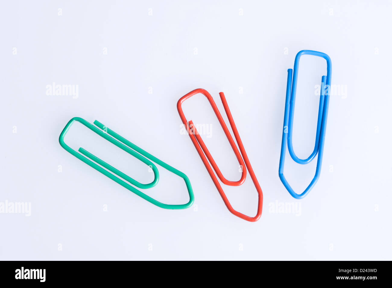 Variety of paper clips on white background Stock Photo - Alamy