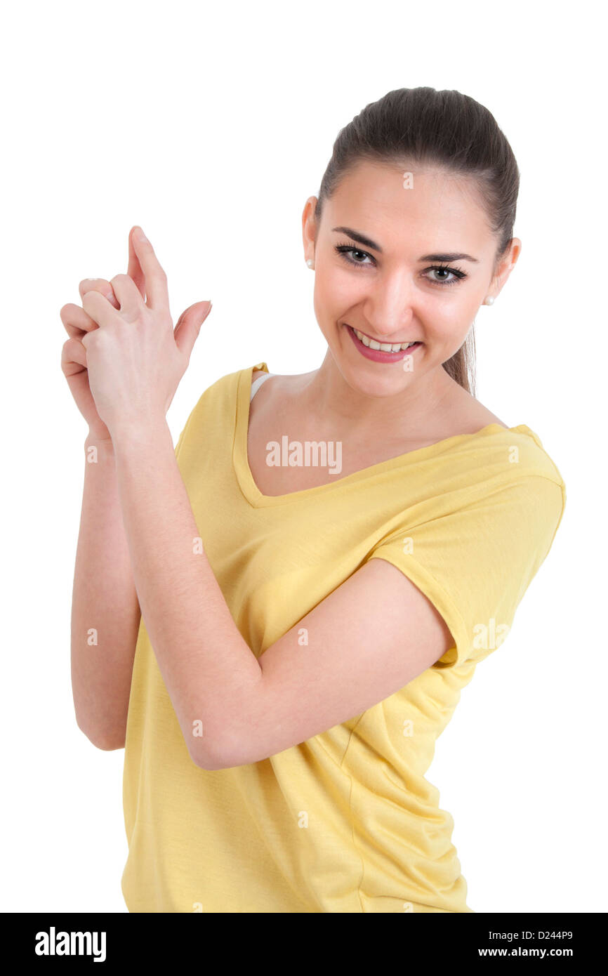 Portrait of young woman pointing sideways with both hands on white ...