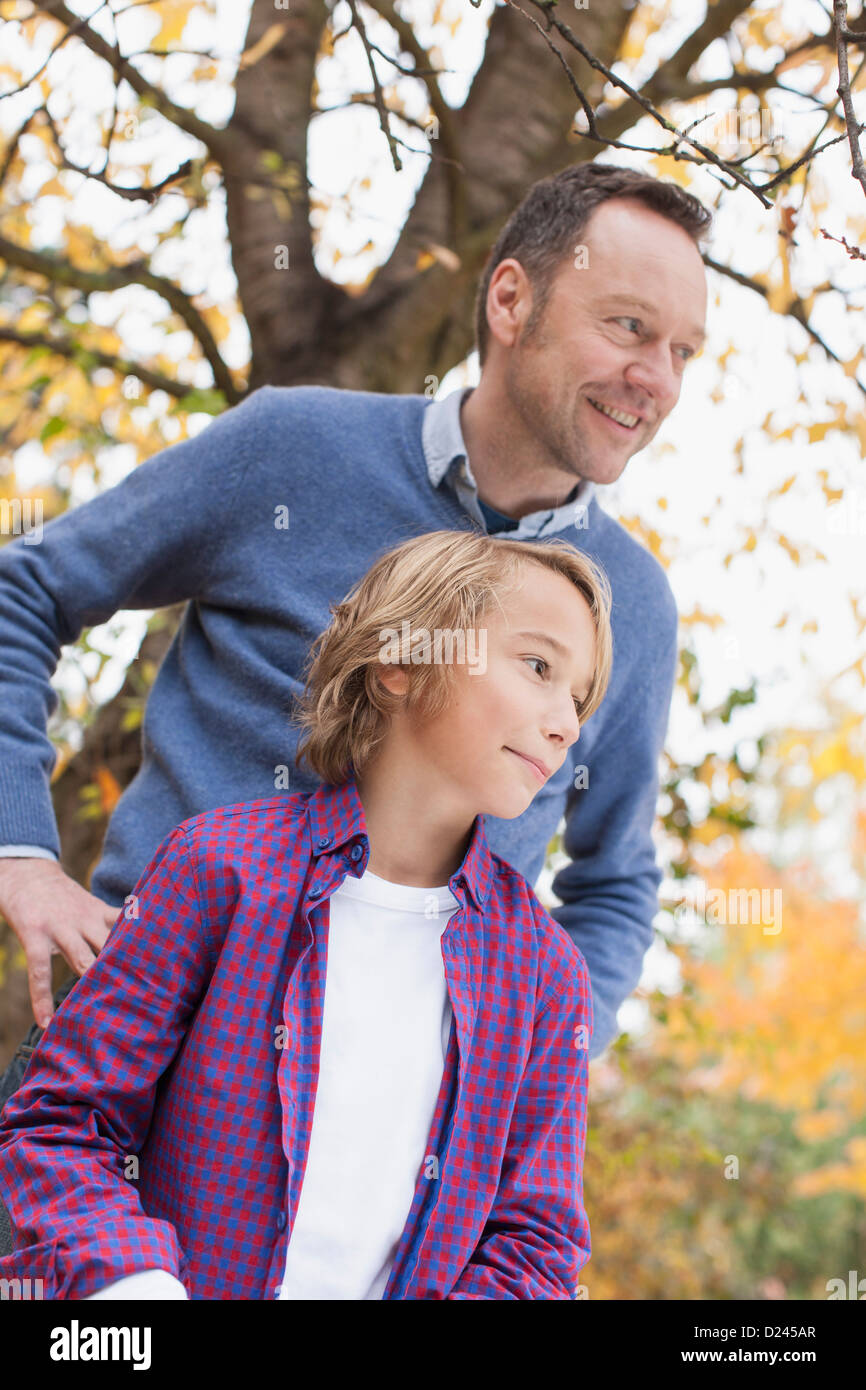 Germany, Leipzig, Father and son looking away, smiling Stock Photo - Alamy