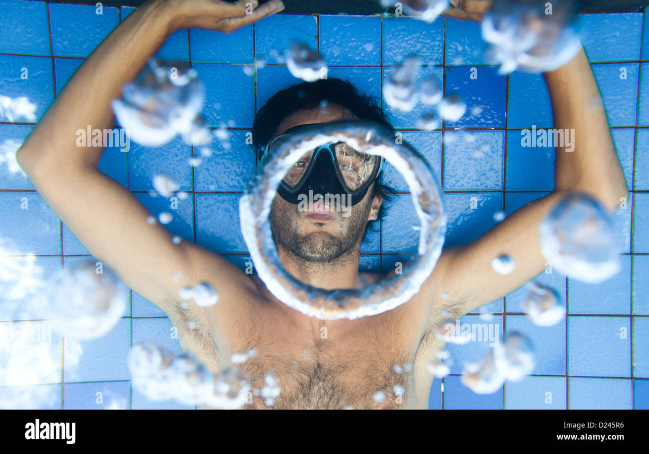 Man making bubble rings underwater in pool Stock Photo - Alamy