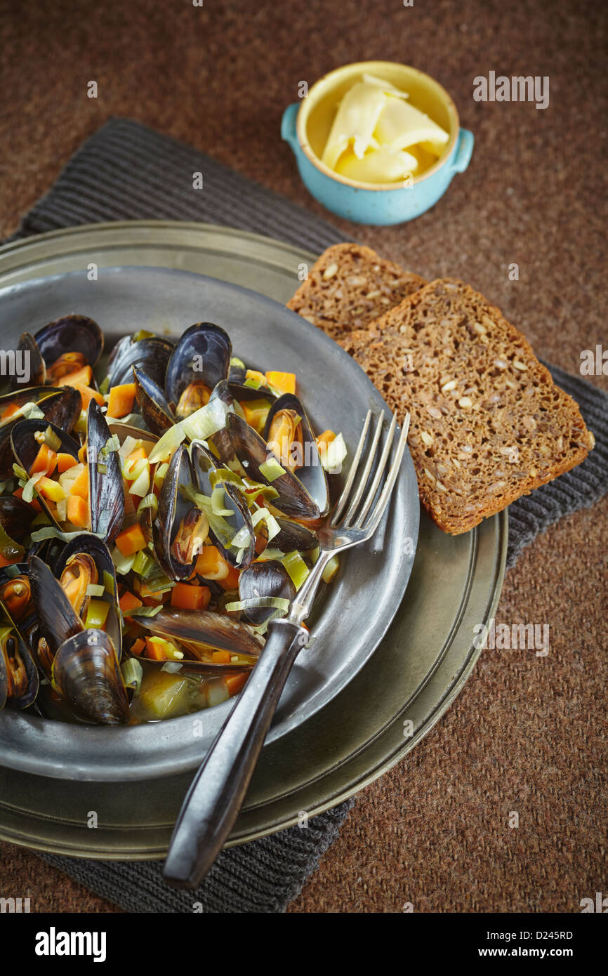 Mussel, whole grain bread with butter in bowl on table Stock Photo - Alamy