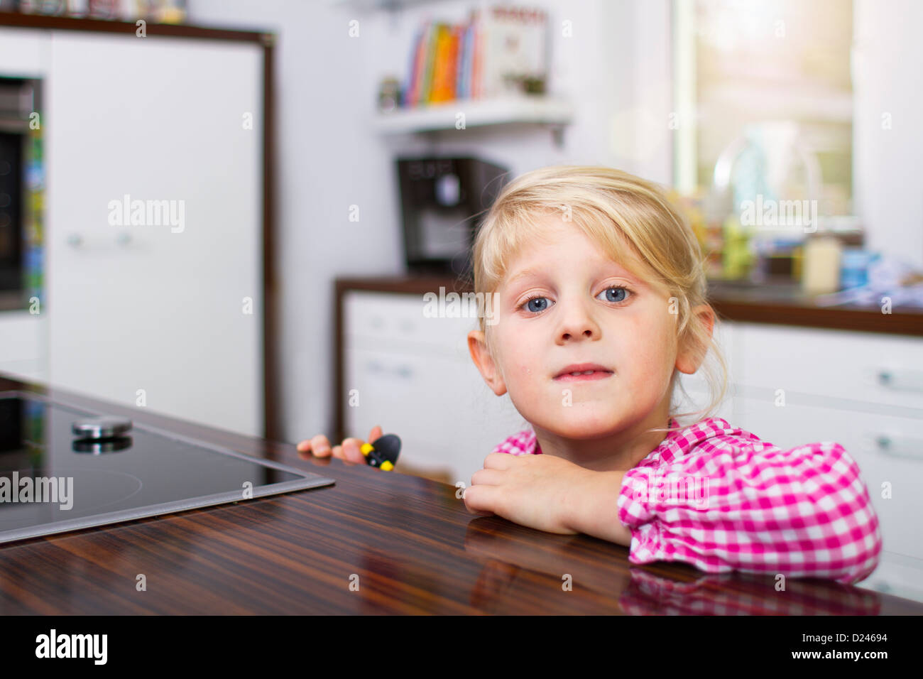Germany, Portrait of girl in kitchen Stock Photo - Alamy