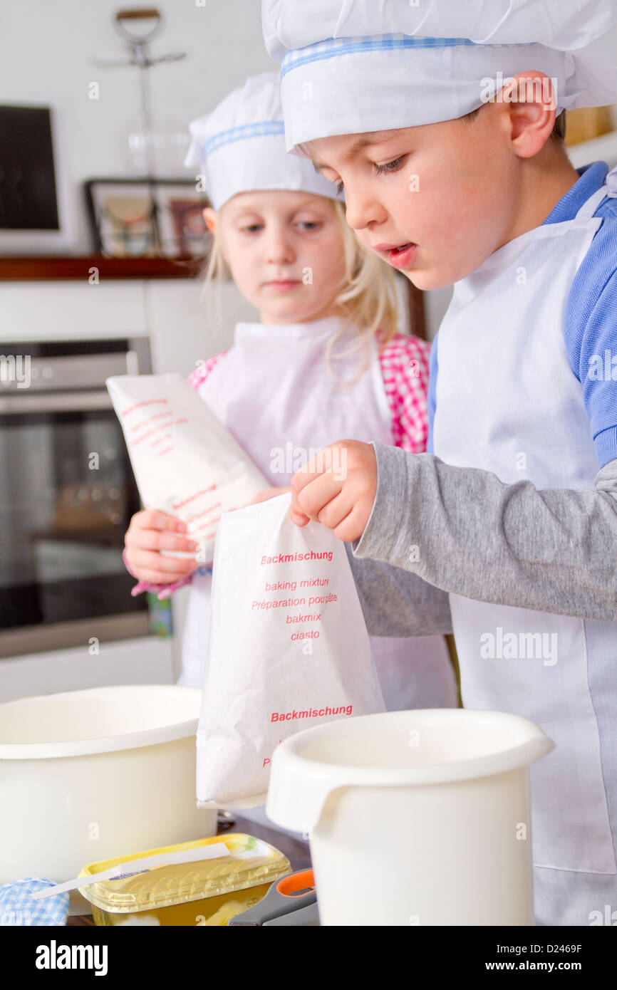 Girl and boy using baking powder hi-res stock photography and images ...