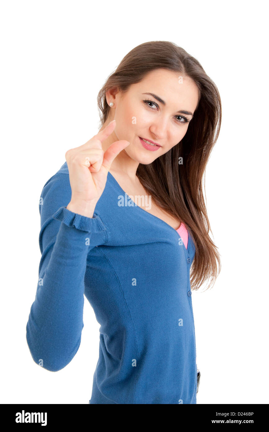 Portrait of young woman showing little bit gesture Stock Photo - Alamy