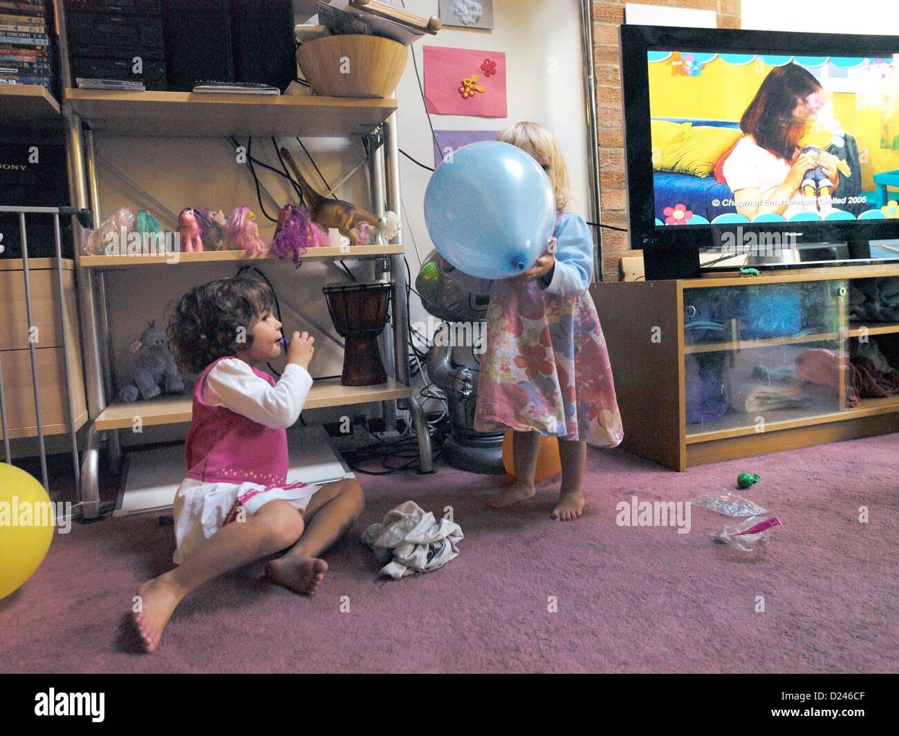 Sisters Playing with Balloons by Wide Screen TV Stock Photo - Alamy