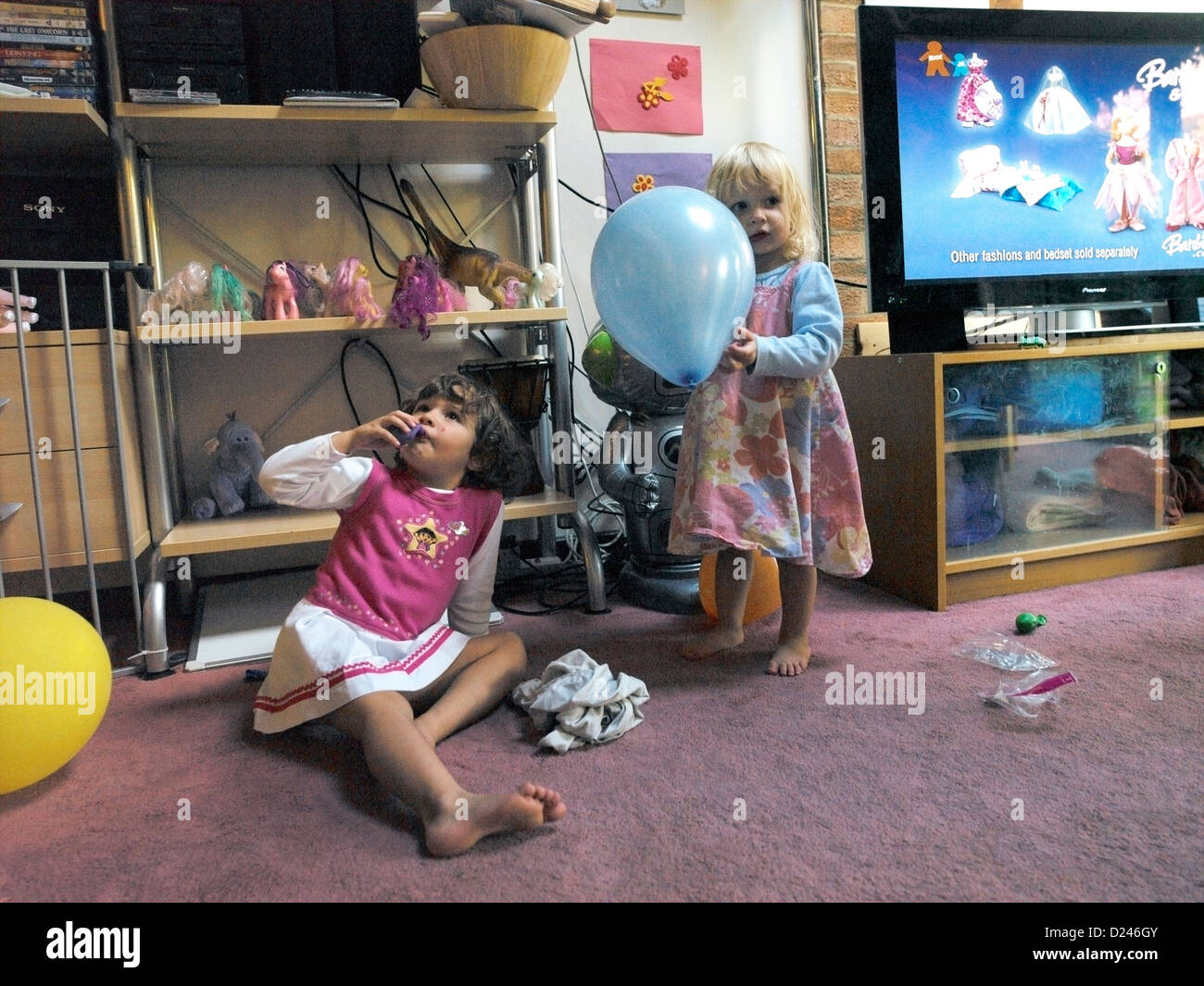 Sisters Playing with Balloons by Wide Screen TV Stock Photo - Alamy