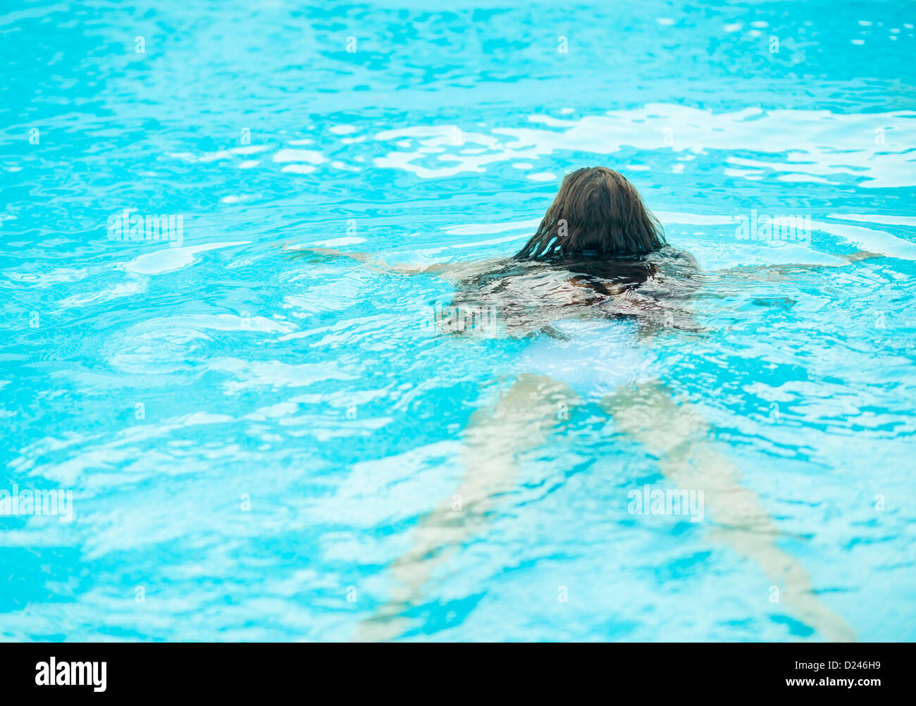 Young woman swimming in pool. Rear view Stock Photo - Alamy