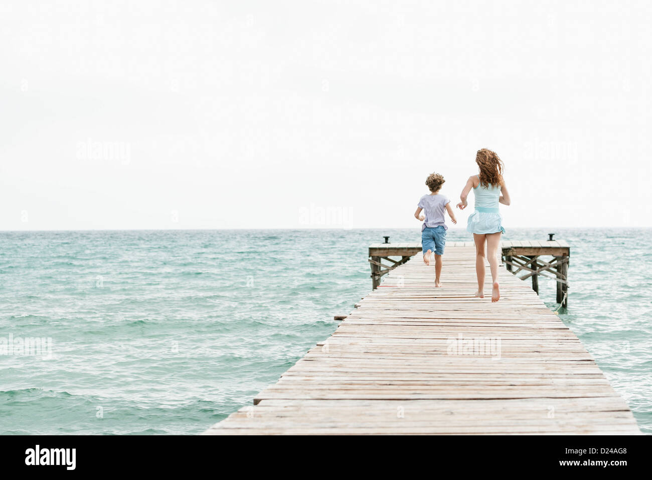 Boy girl jumping water hi-res stock photography and images - Alamy
