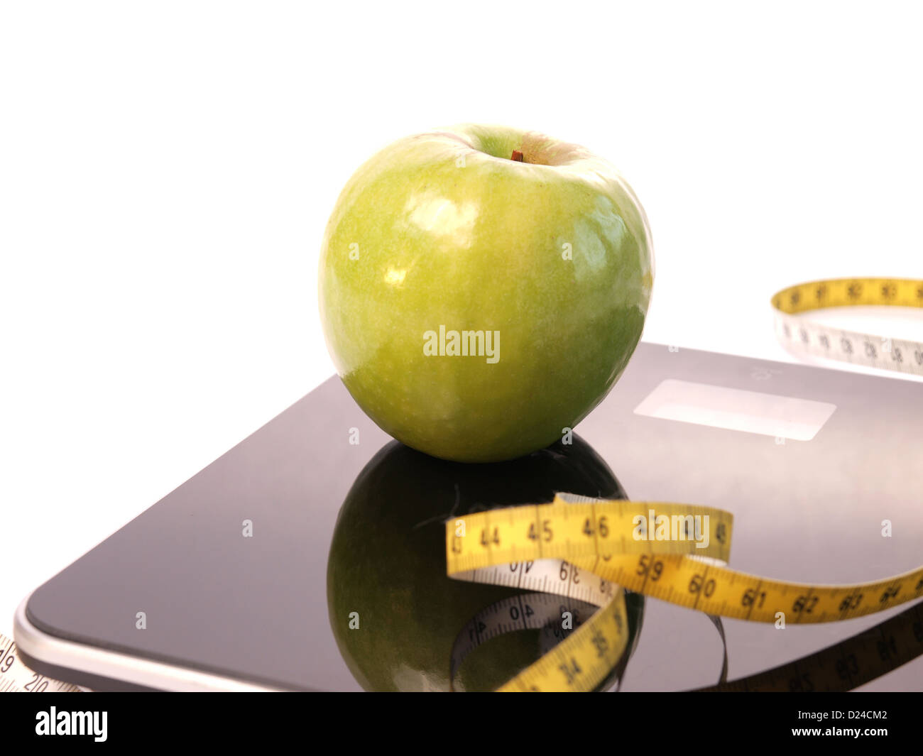 Scale with an apple and measuring tape Stock Photo - Alamy