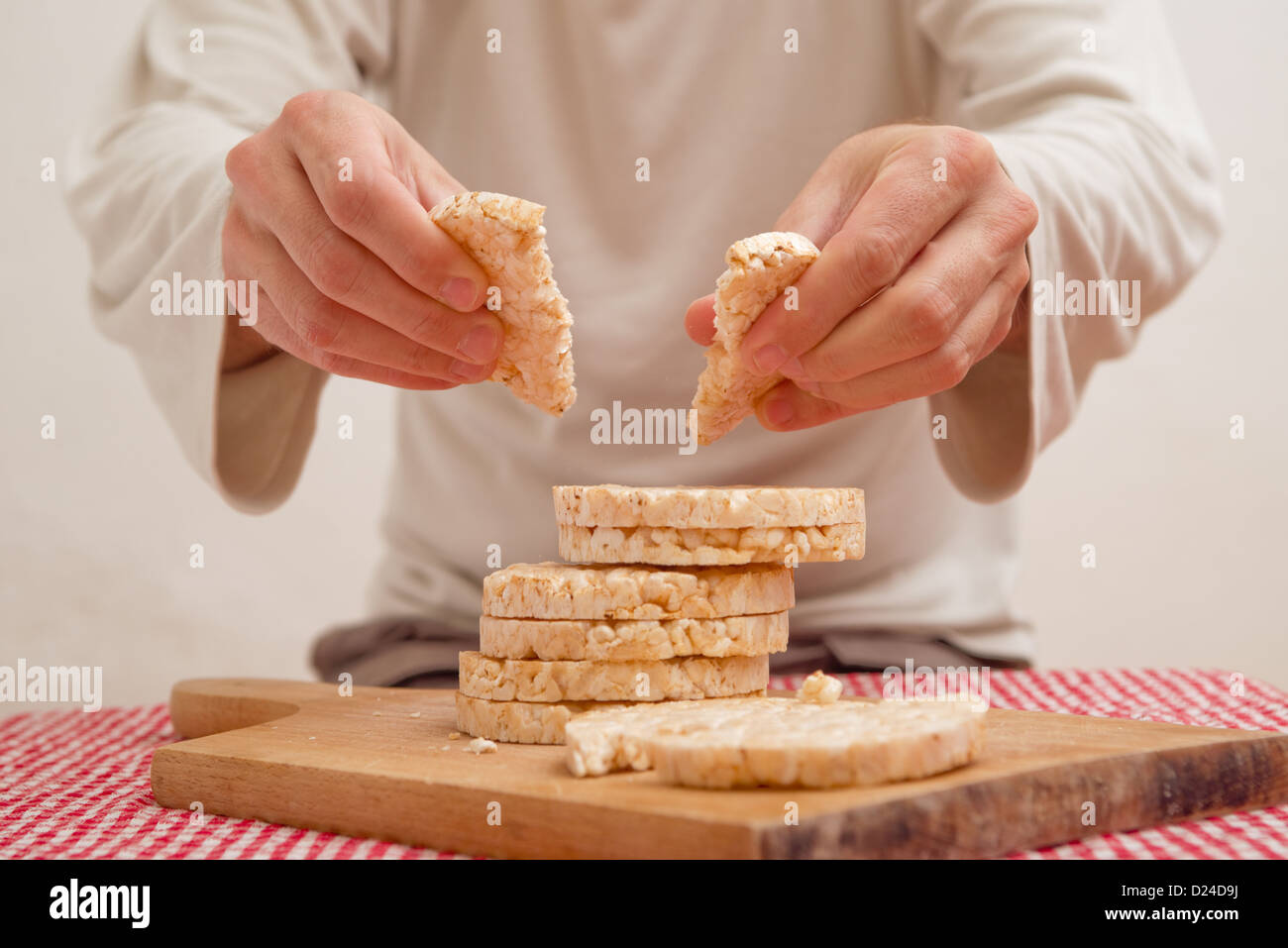 Man holding tasty rice cake on a kitchen table Stock Photo - Alamy