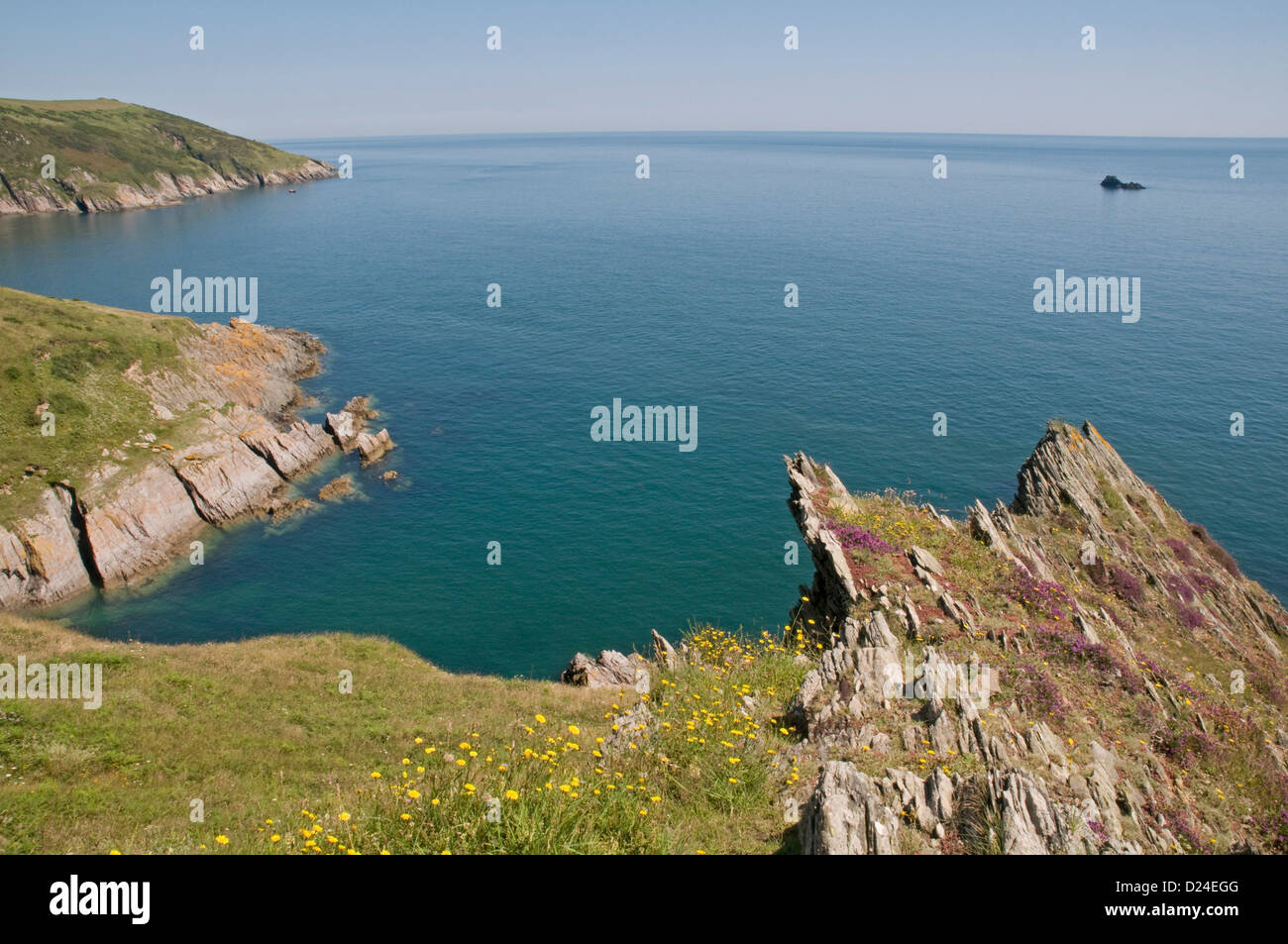 Impressive tilted rock strata at Pudcombe Cove on Devon's south coast ...