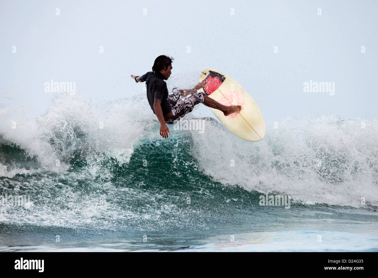 Surfer in ocean on sunset. Bali. Indonesia Stock Photo - Alamy