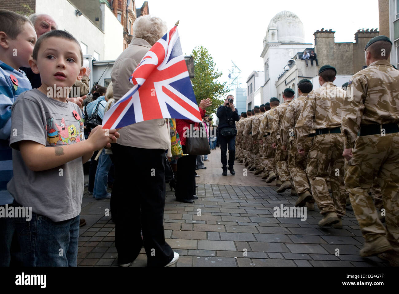 A child waving a national flag at a welcome home parade for British ...