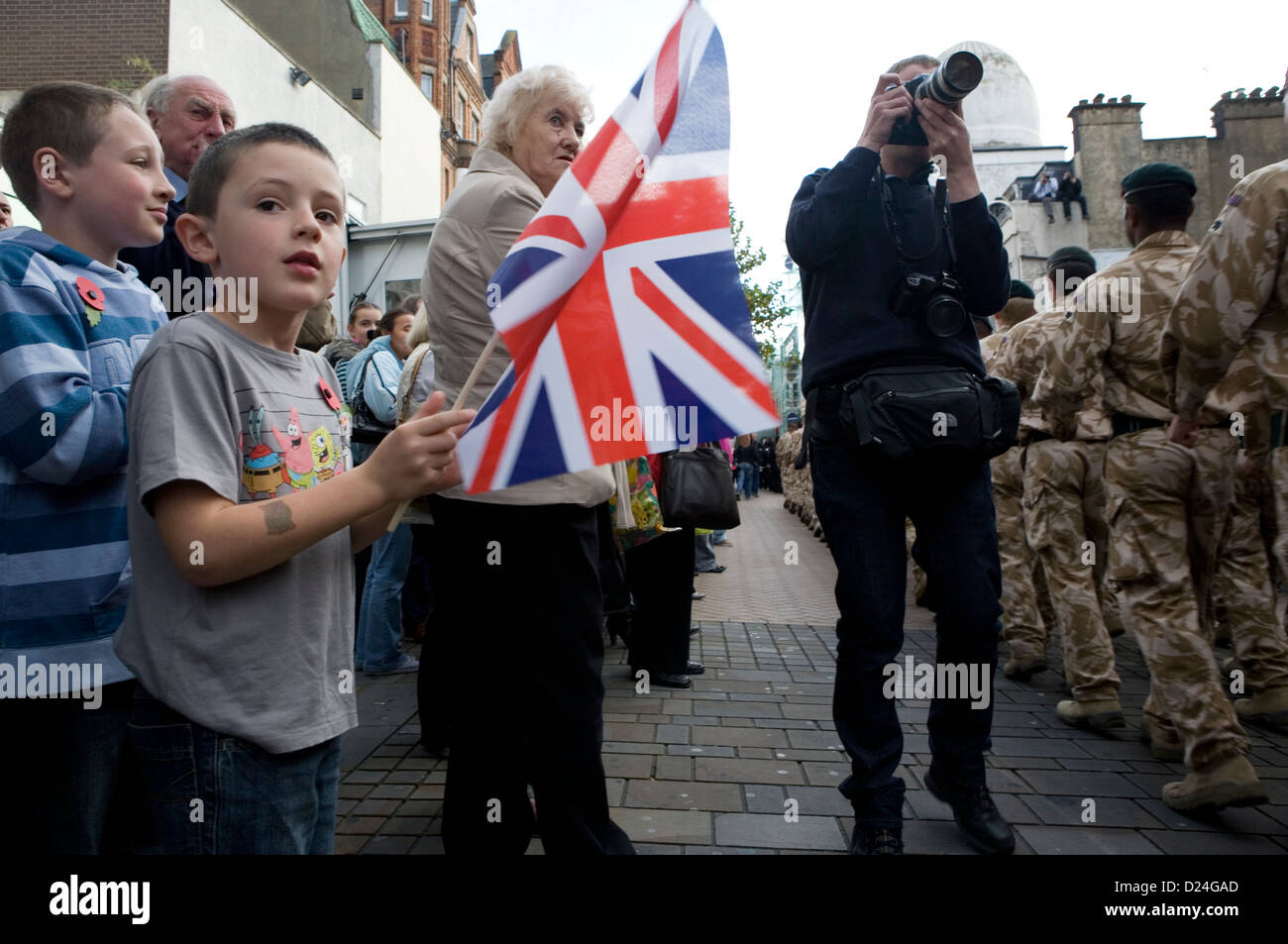 A child waving a national flag at a welcome home parade for British ...
