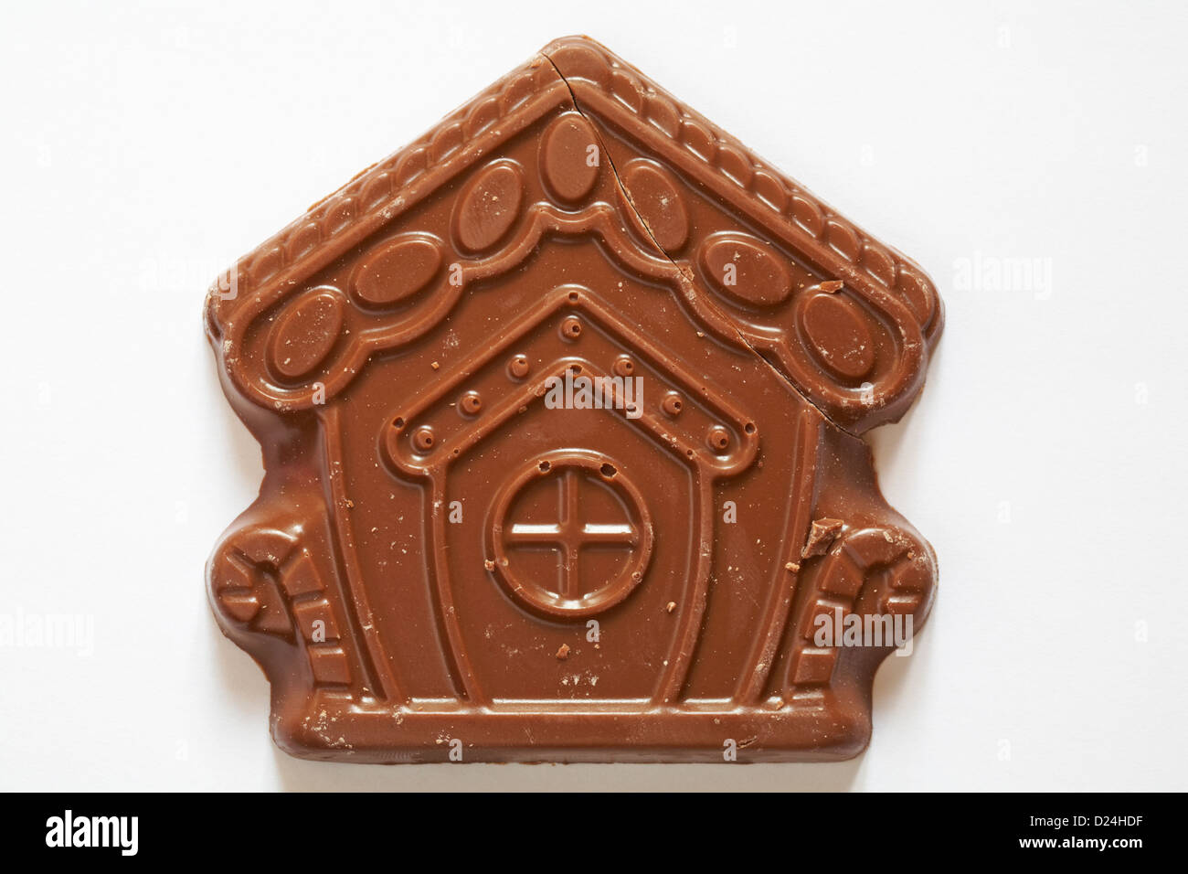 handmade milk chocolate house with crack isolated on white background ...