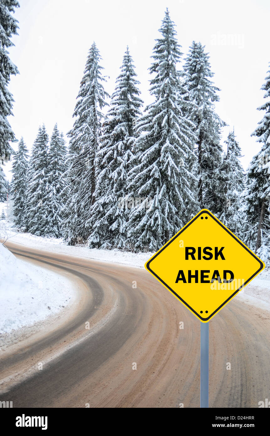 "RISK AHEAD" sign against winter road Stock Photo - Alamy